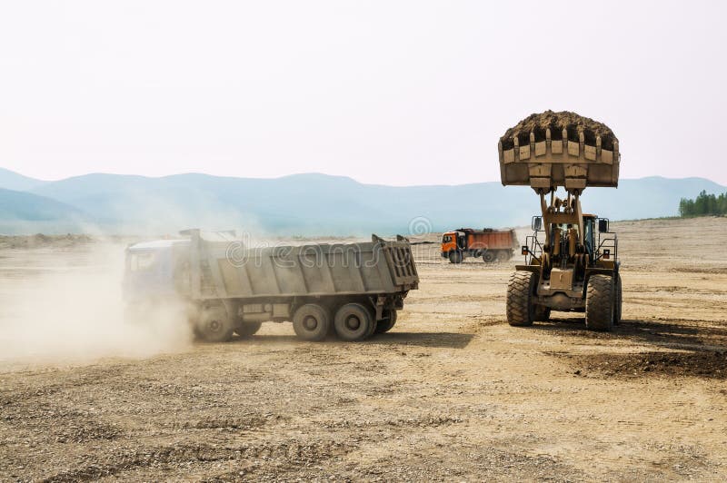 Front loader in operation stock photo. Image of mountainous - 194538290