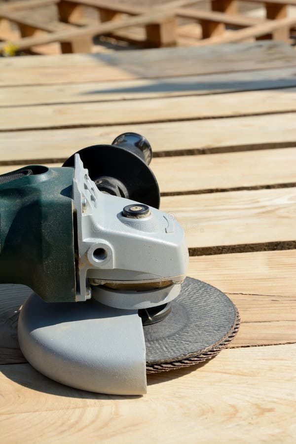 Front Part of Angle Grinder with Abrasive Disc on Planks Stock Photo ...
