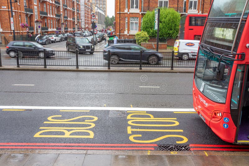 Front Part of Bus Arriving at the Stop, Written on the Ground in Yellow ...