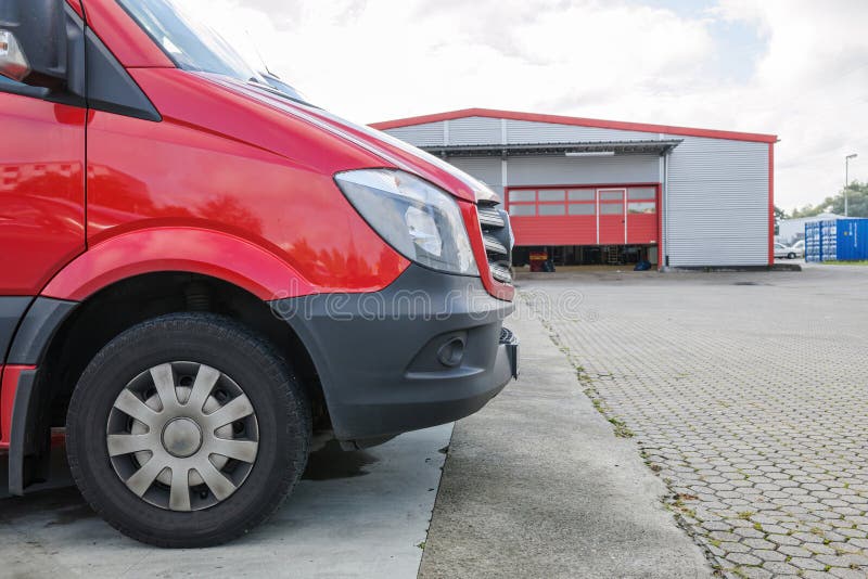 Front Part of a Red Delivery Van in Front of Logistics Warehouse Stock ...