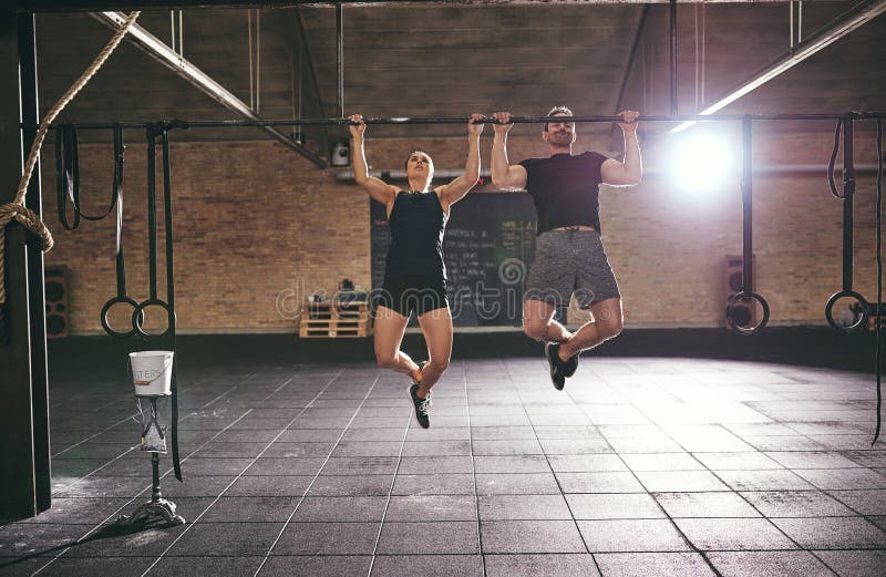 Front Shot of Two Sportsmen Doing Pull-ups Stock Image - Image of ...