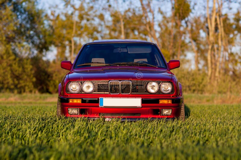 Front Side of an Old German Car that Stands on Green Grass at Sunset ...
