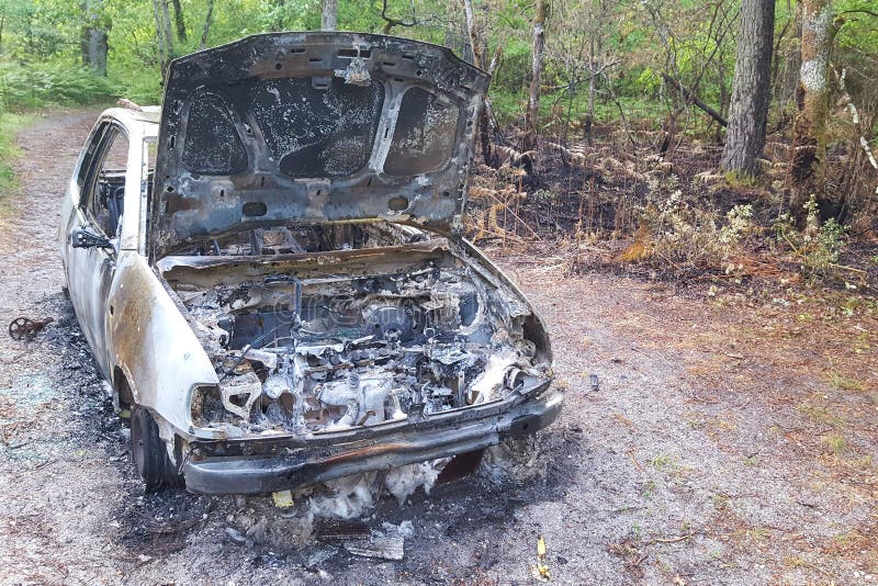 Side View of Abandoned Burned Out Car Left on Side of the Road with ...
