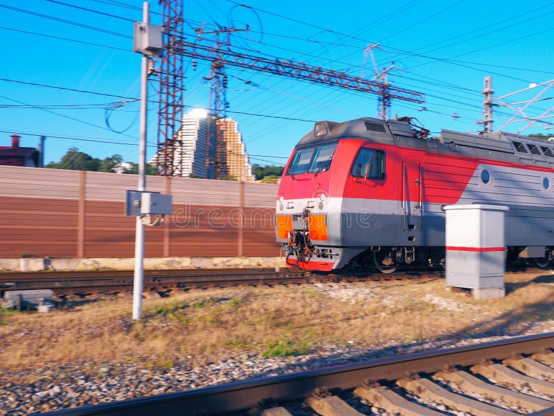 The Front of a Train Racing Along the Rails Against the Backdrop of a ...