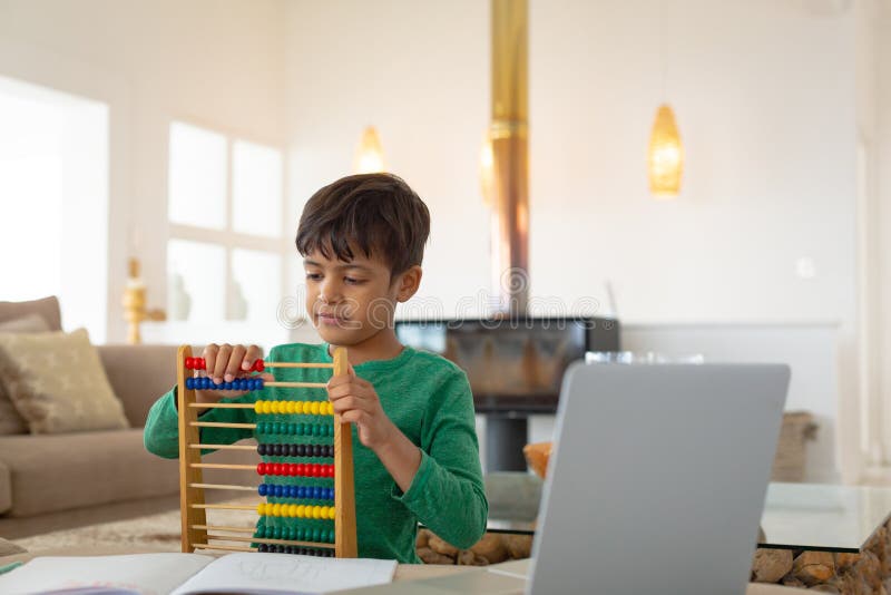 Boy Learning Mathematics with Abacus in a Comfortable Home Stock Photo ...