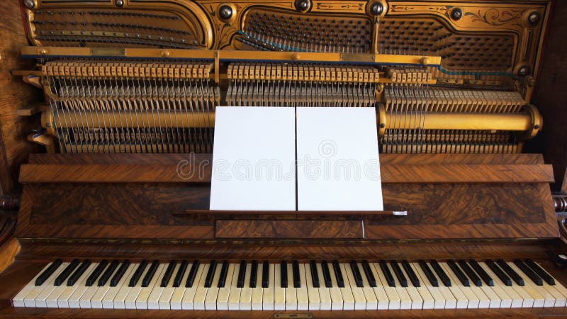 Front View of an Antique Piano with the Keyboard Open and Two Sheets of ...