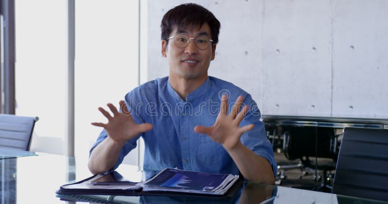 Front View of Asian Male Executive Interacting in the Office Stock ...