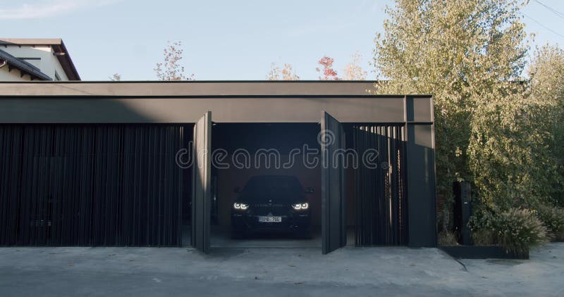 Front View on Black Car Leave Modern Garage with Automatic Open Gate ...