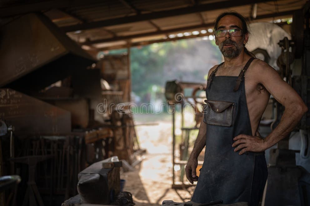 Front View of Blacksmith Posing in Front of the Camera in His Workshop ...