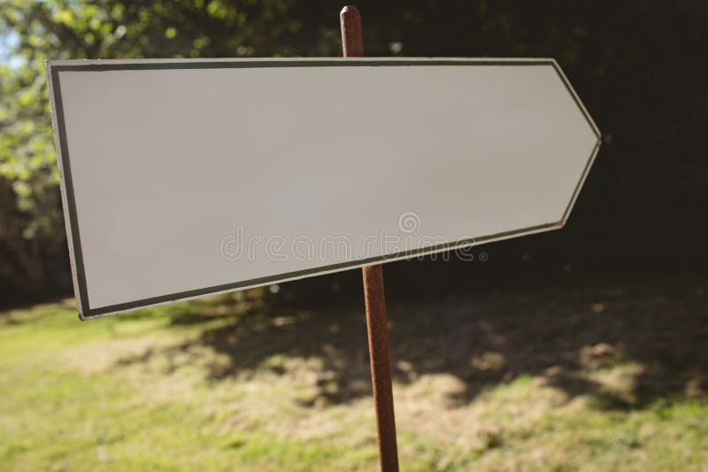 Front View of Blank Direction Sign Pointing To the Right Against Forest ...