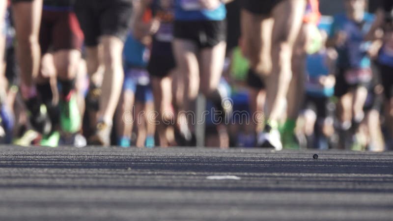 Front View of Blurred Runner Legs Running Marathon with Public Voices ...