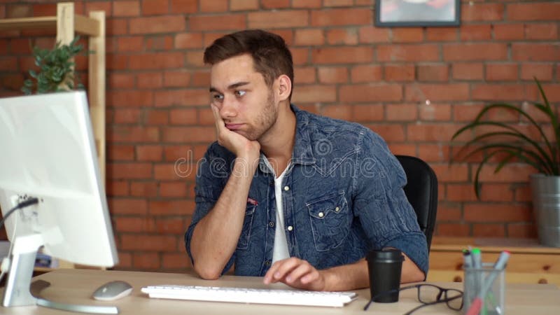 Front View of Bored Young Man Freelancer Leaned on Chin and ...