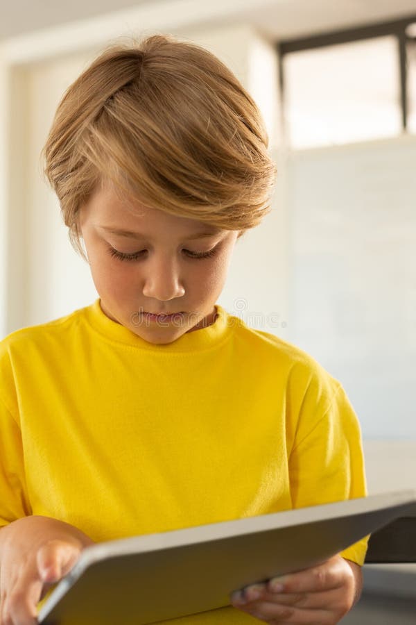 Front View of Boy Using Digital Tablet in a Classroom Stock Image ...