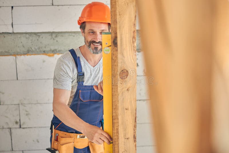 Smiling Male Worker Using a Construction Tool Stock Photo - Image of ...