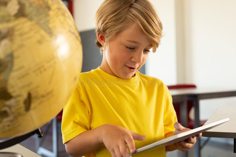 Boy Using Digital Tablet in a Classroom Stock Photo - Image of ...