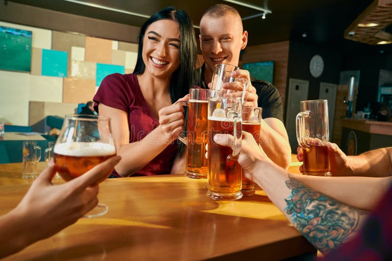 Front View of Cheerful Pair Laughing while Drinking Beer Stock Image ...
