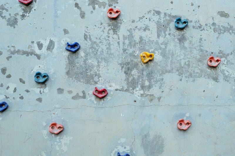 Front View of Concrete Climbing Wall with Various Colored Handholds ...