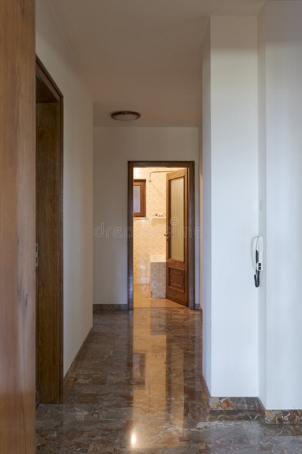 Front View Corridor with an Open Door To the Bathroom at the End ...