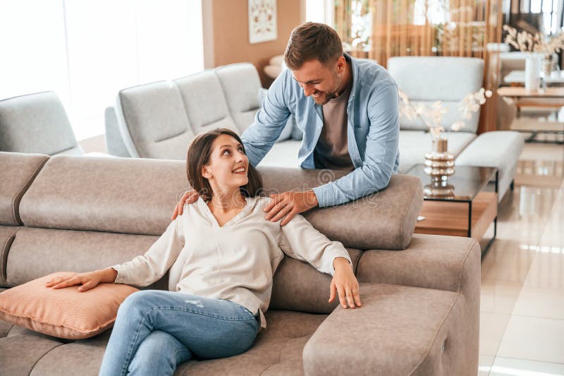 Front View. Couple Choosing the Sofa and Bed in the Store Stock Image ...