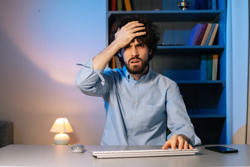 Front View of Depressed Young Man Putting Hand Over Forehead Sitting ...
