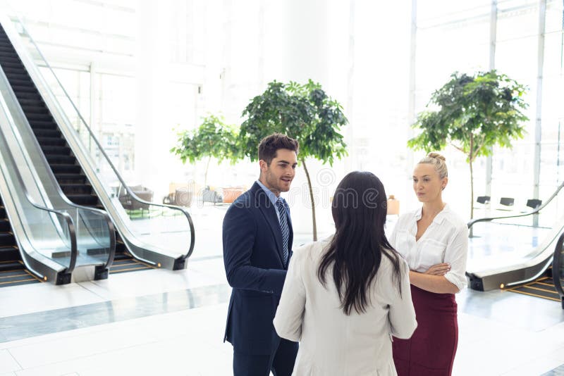 Diverse Business People Interacting with Each Other while Standing in ...