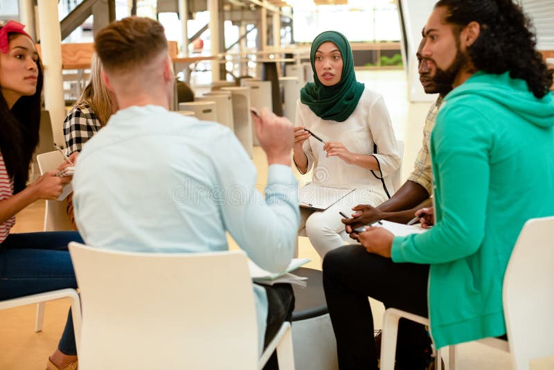 Business People Sitting Together and Having a Group Discussion in a ...