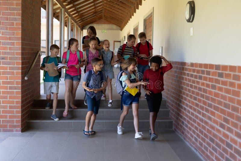 Group of School Pupils Walking in an Outdoor Corridor at Elementary ...