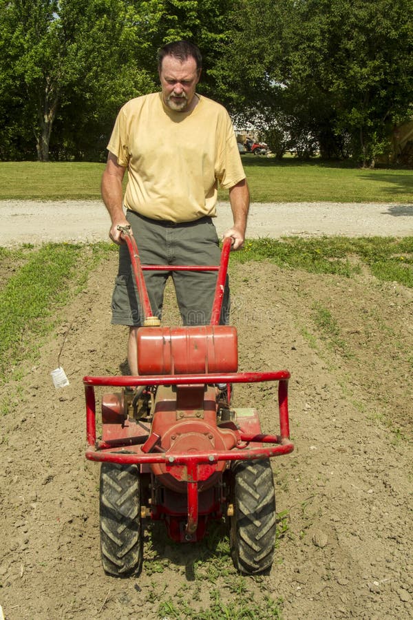 Front View Farm Using a Garden Tiller Stock Photo - Image of tiller ...