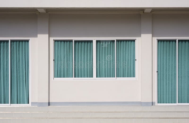 Front View of Glass Sliding Doors and Windows with Blue Curtains Inside ...
