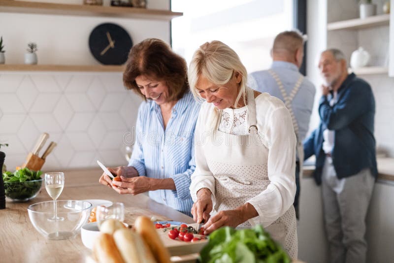Group of Senior Friends at Dinner Party at Home, Cooking. Stock Image ...