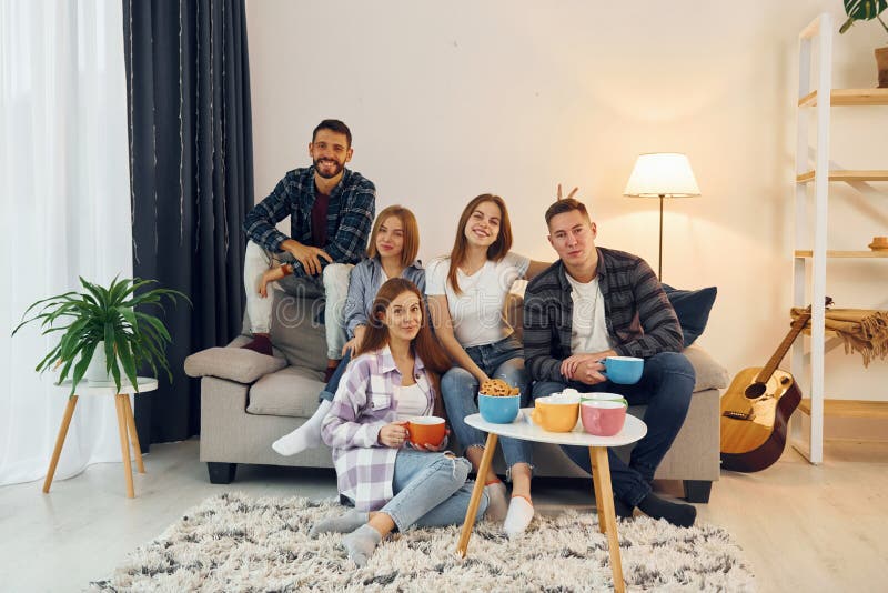 Front View. Group of Friends Have Party Indoors Together Stock Image ...