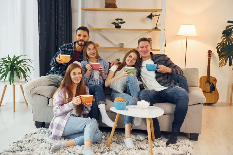 Front View. Group of Friends Have Party Indoors Together Stock Image ...