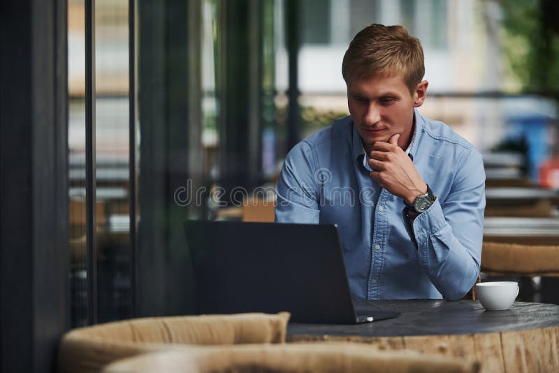 Front View of Guy that is in Modern Cafe with His Laptop at Daytime ...