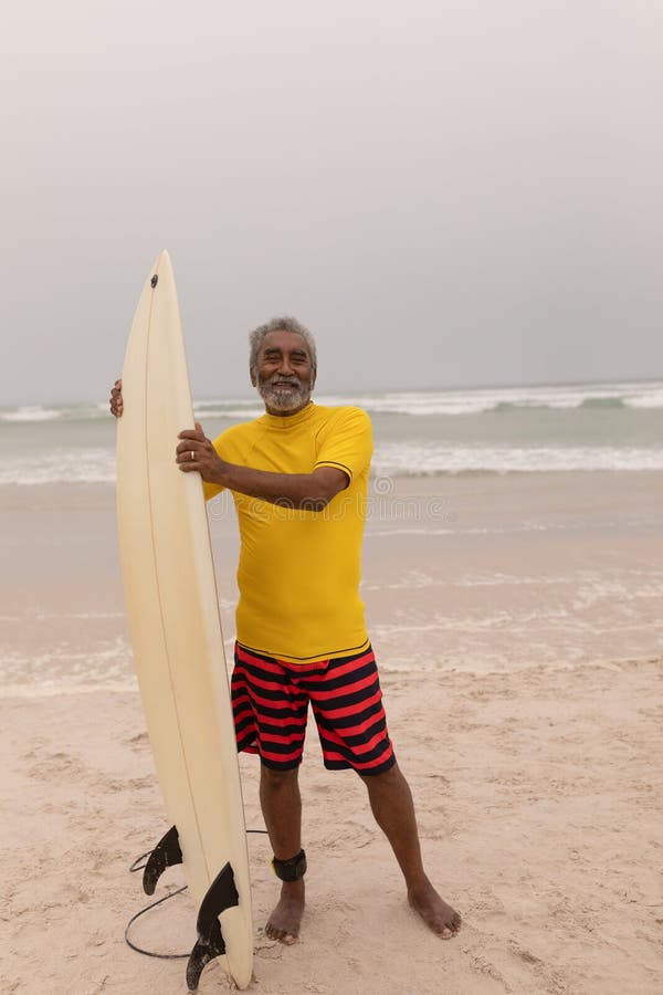Happy Senior Male Surfer Standing with Surfboard and Looking at Camera ...