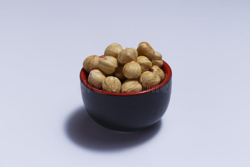 Front View of Hazelnuts Inside a Red Bowl Isolated on White Background ...