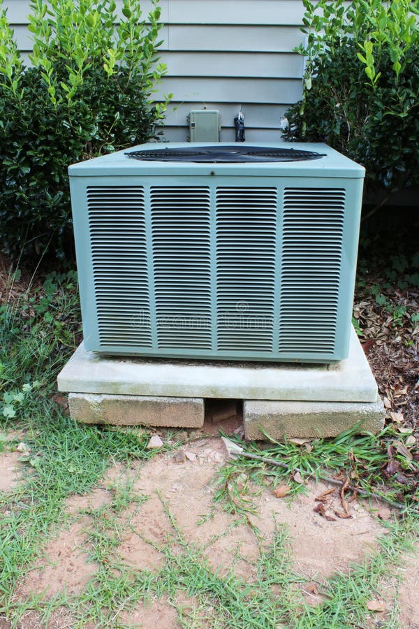 Front View of a Heat Pump Showing Unstable Base Propped Up with Blocks ...