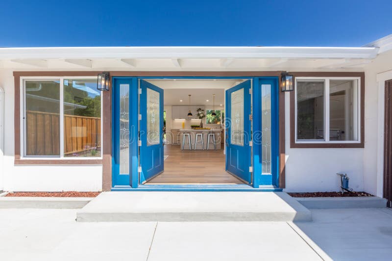 Front View of a House with Open Blue Doors with Modern Kitchen Interior ...