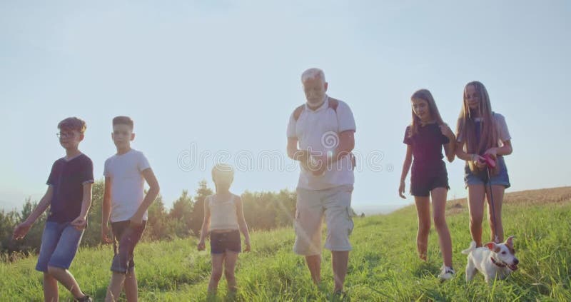 Front View of Kids Going Forward, Walking with Jack Russel Terrier and ...