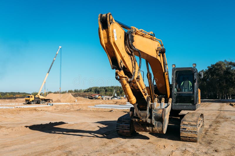 Front View of a Large Yellow Excavator at a Construction Site Stock ...