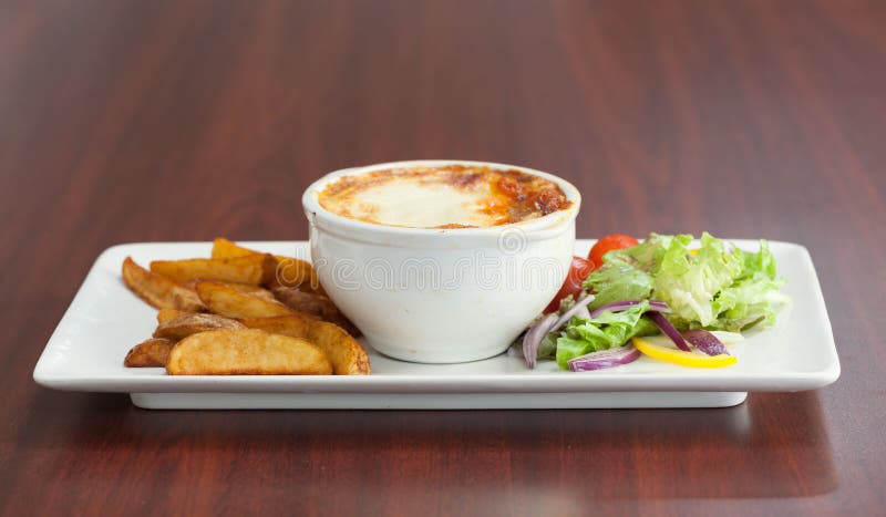 Front View of Lasagna with Potatoes and Salad Stock Photo - Image of ...