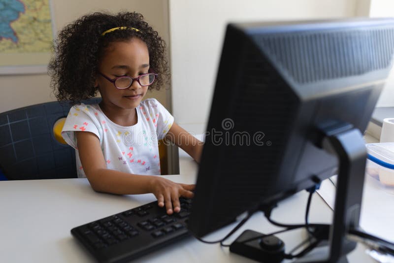 Front View Little Schoolgirl Using Desktop Pc at Desk in Classroom ...