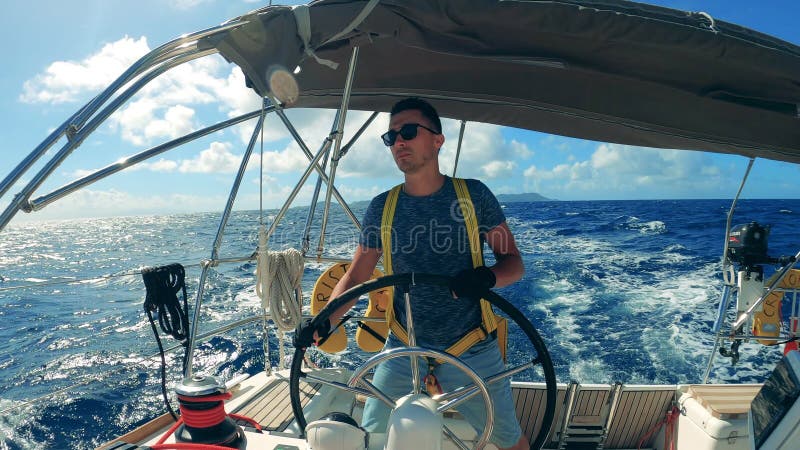 Front View of a Man Navigating a Boat while Standing at the Wheel Stock ...