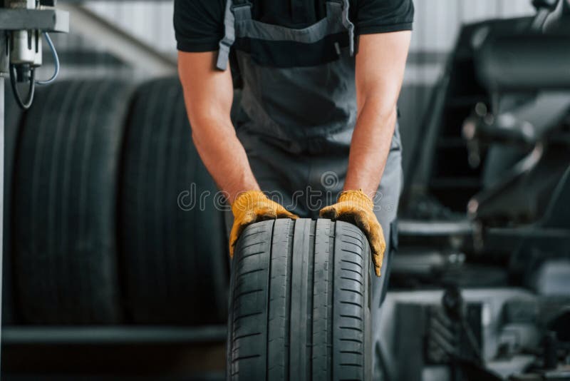 Front View. Man in Uniform is Working in the Auto Service Stock Photo ...