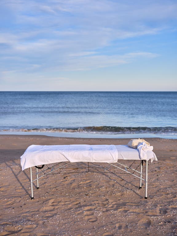 Front View of a Massage Table Placed on the Sand of a Beach with the ...