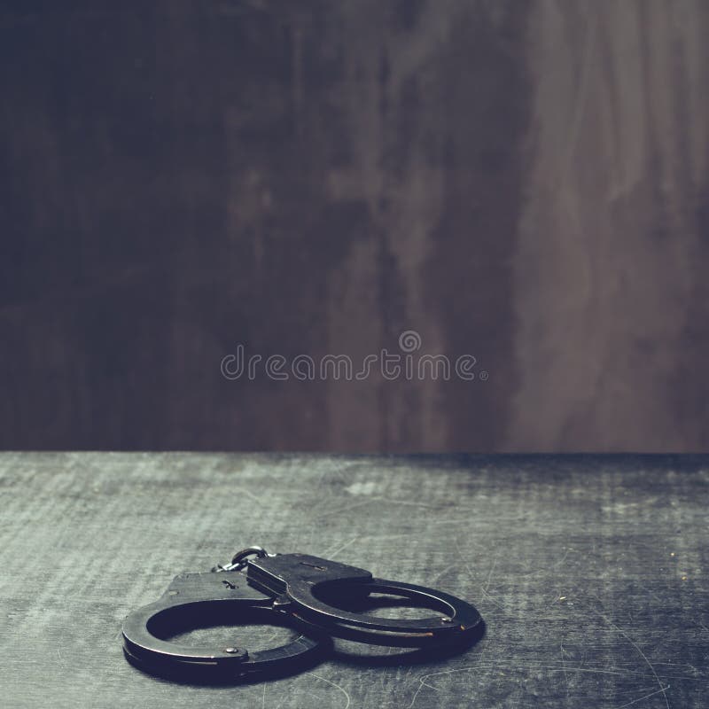Front View of Metal Handcuffs on Table in the Interrogation Room Stock ...