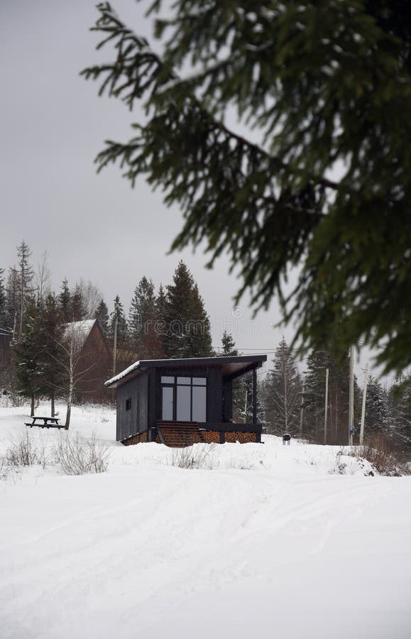 Front View of a Modern Black Tiny Cabin on Snowy Mountains Stock Image ...