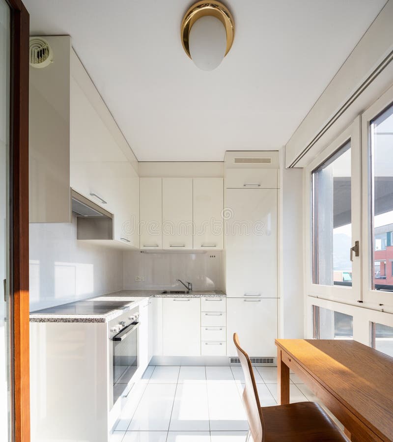 Front View Modern Kitchen with Wooden Table and Window Stock Photo ...