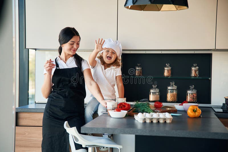 Front View. Mother with Her Daughter are Preparing Food on the Kitchen ...