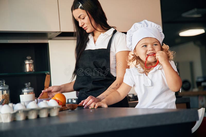 Front View. Mother with Her Daughter are Preparing Food on the Kitchen ...