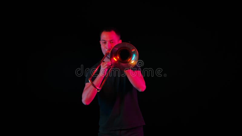 Front View of a Musician Playing the Trombone in the Studio Against a ...